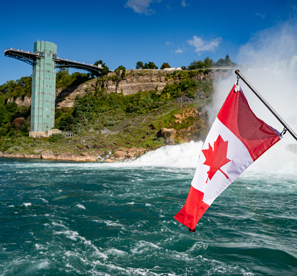 Canadian flag in front of Niagara Falls.